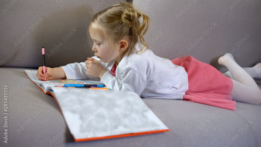 Cute little girl drawing with markers in coloring book, art therapy and ...