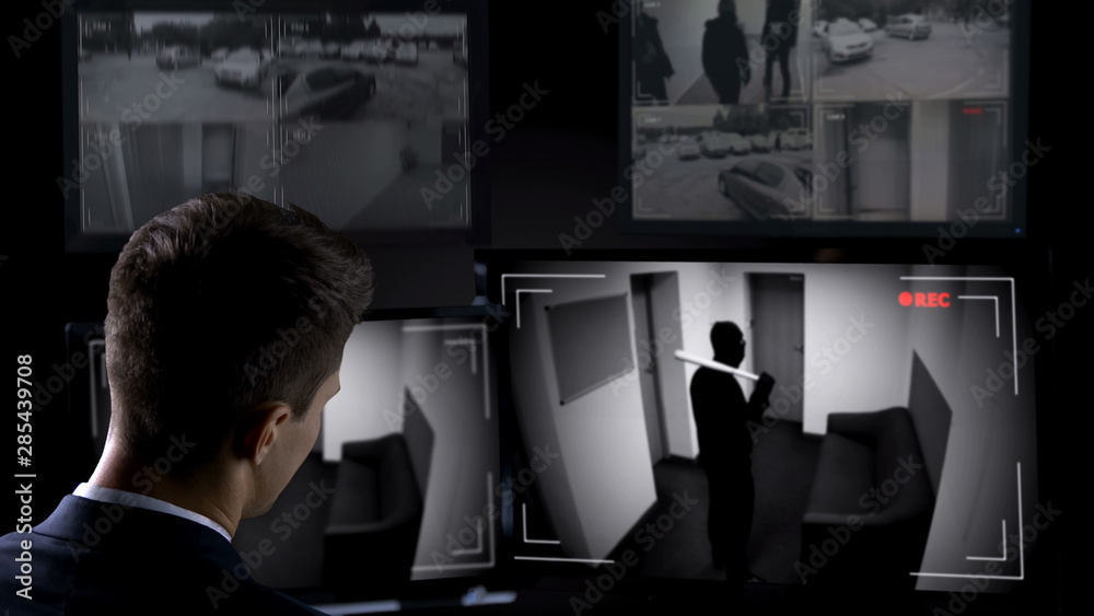 Male security guard watching bandit brake in building, CCTV footage ...