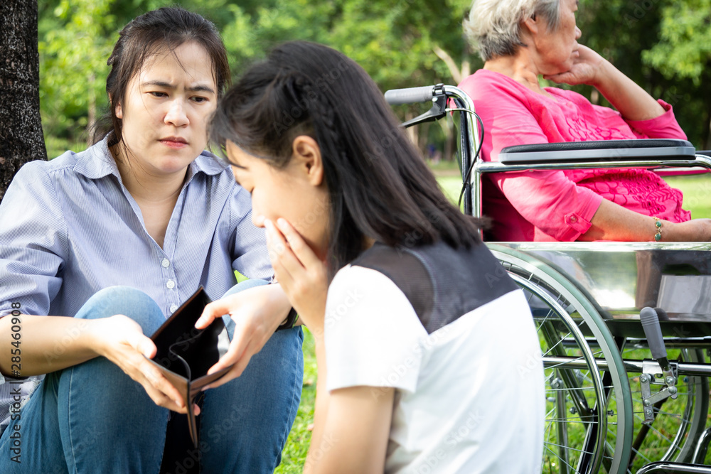 Bankrupt asian family,mother showing her empty wallet for daughter to ...
