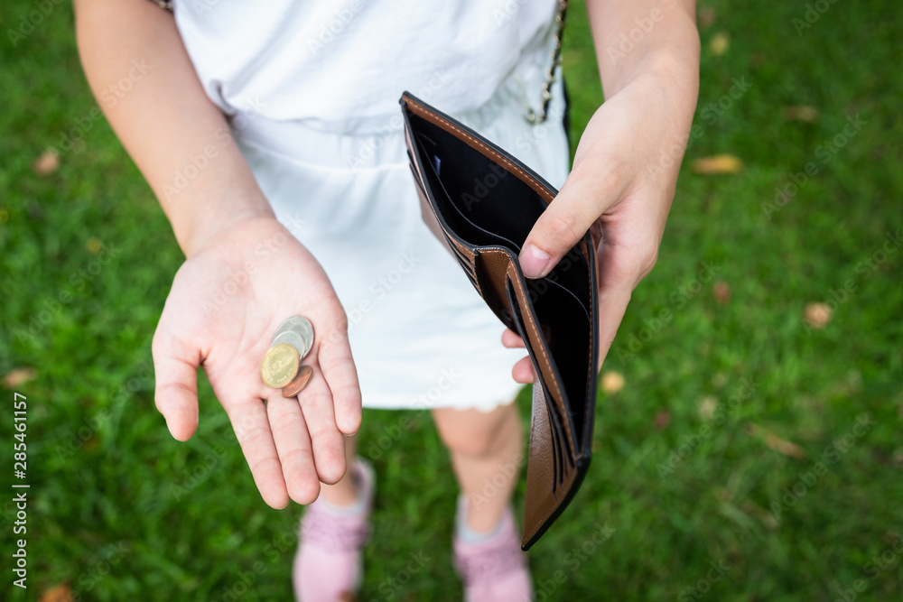 Asian child girl shows her wallet,hand open an empty wallet, spend ...