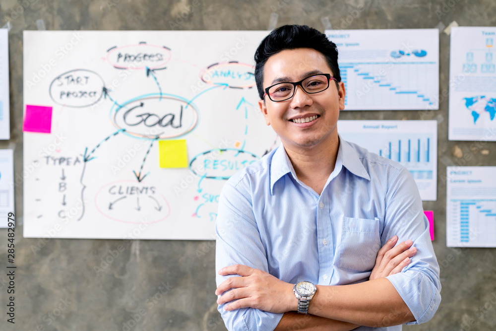 Portrait of Happy asian man in blue shirt standing in smart office ...