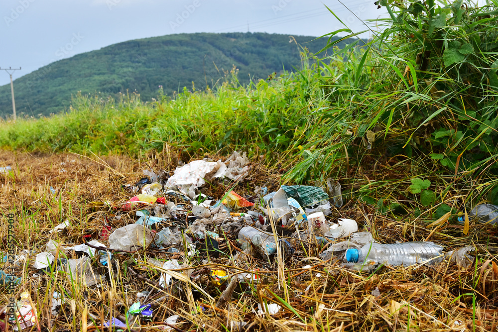 Dirty garbage plastic pollution in grass nature Stock Photo | Adobe Stock