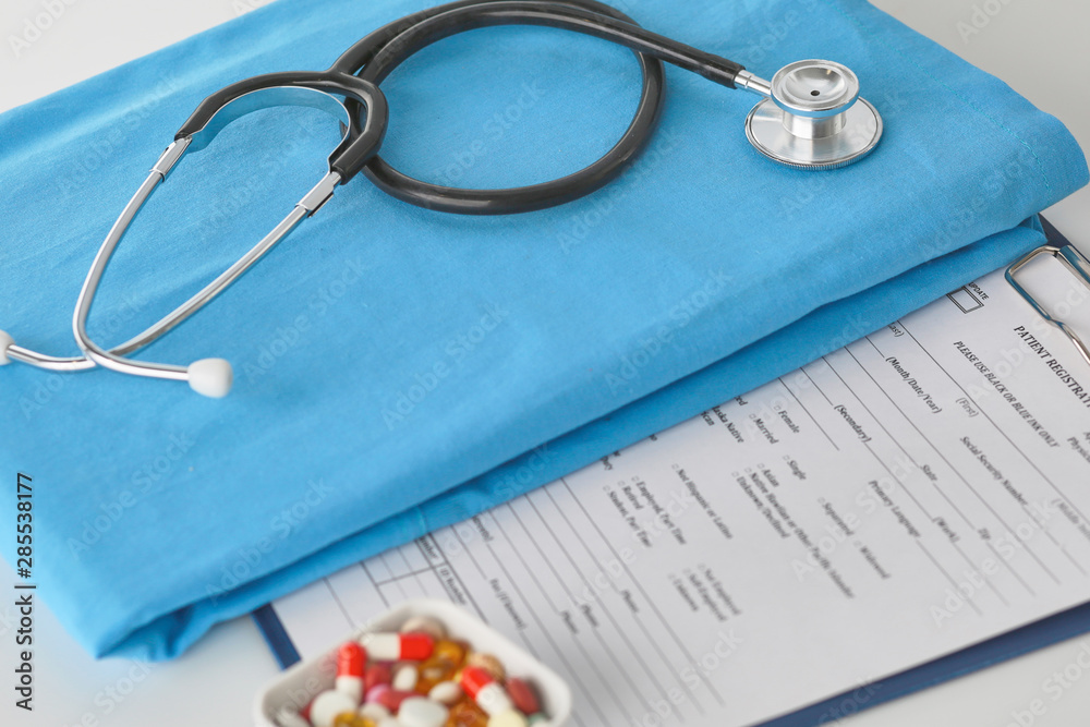 Doctor's workspace working table with patient's discharge blank paper ...