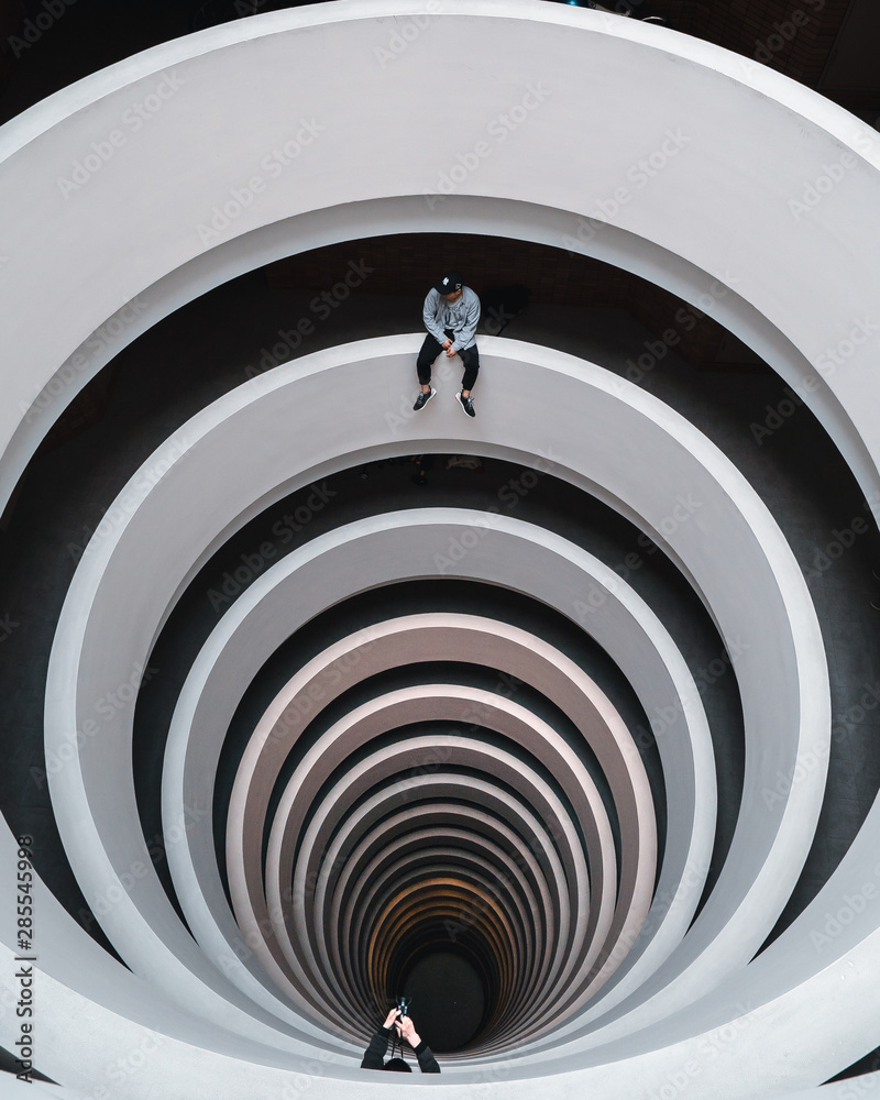 Tow people across from each other on a spiral walkway. Stock Photo ...