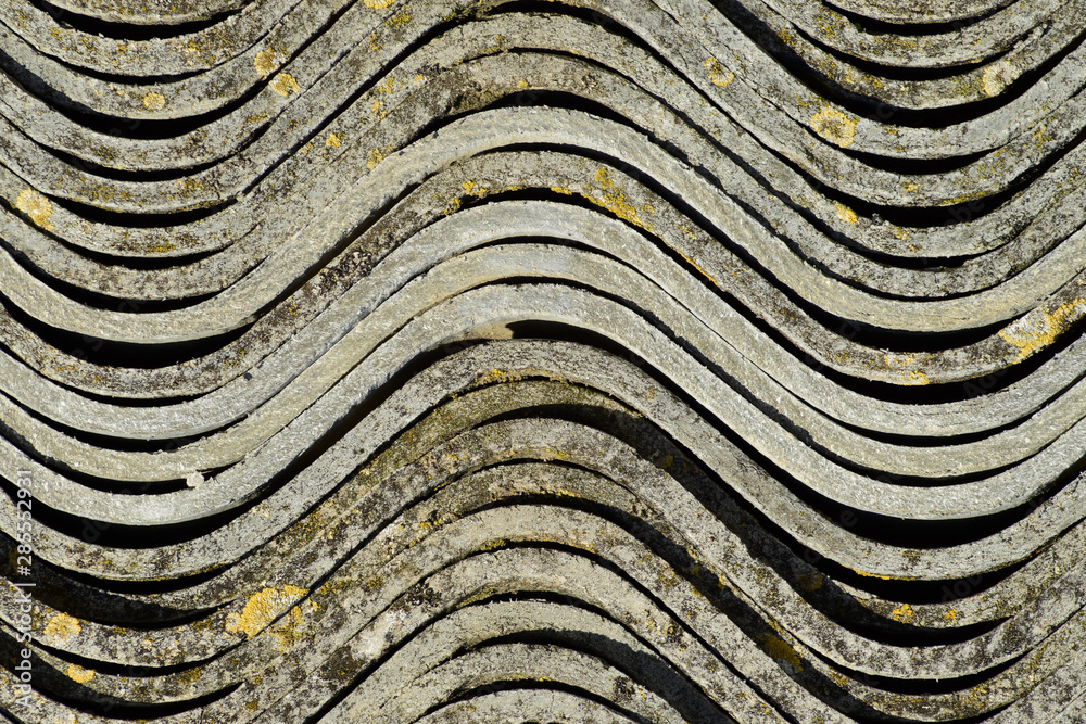 Corrugated slate lies in a pile, side view background texture of slate ...