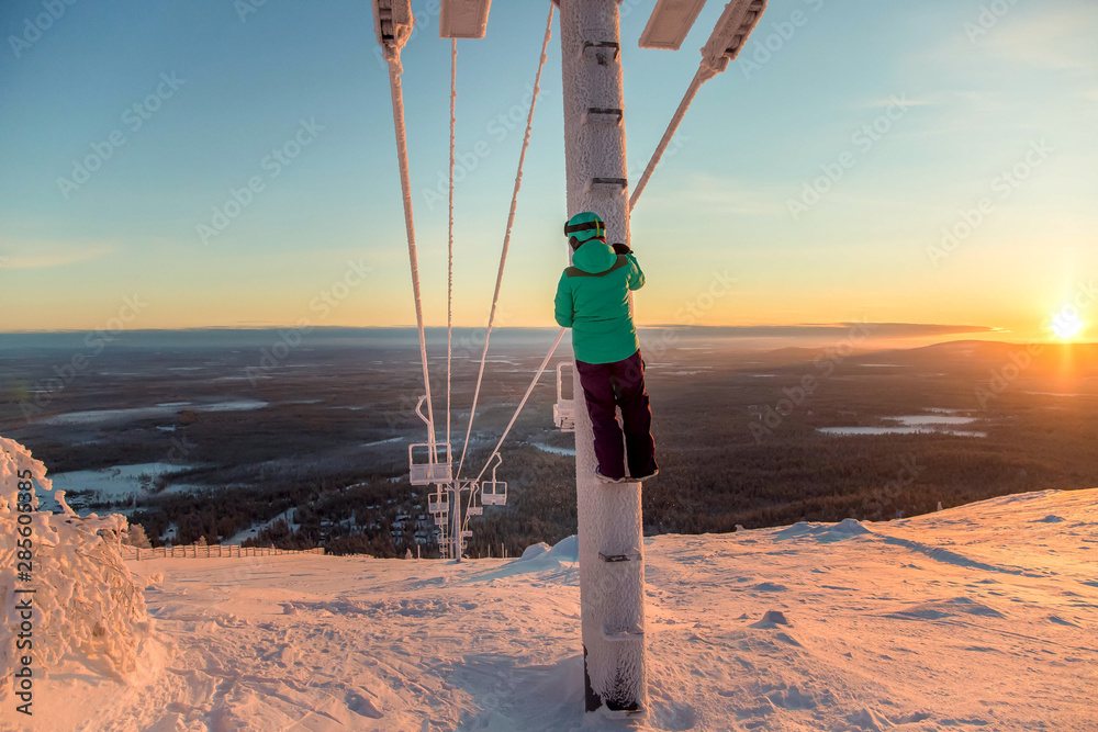 Snowboarder ride on the top of snowy hill in ski resort during calm ...
