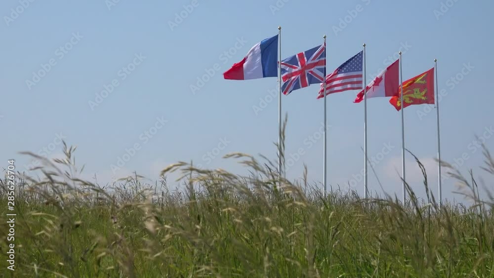 The flags of France, Great Britain, The US, Canada and Normandy fly ...