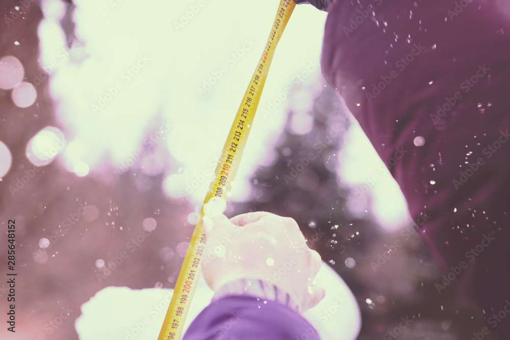 young people measuring the height of finished snowman Stock Photo ...