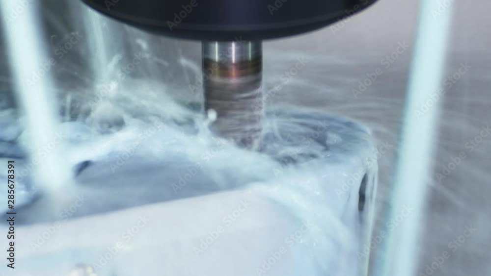 Hole making process. CNC milling machine cutting the raw material with ...