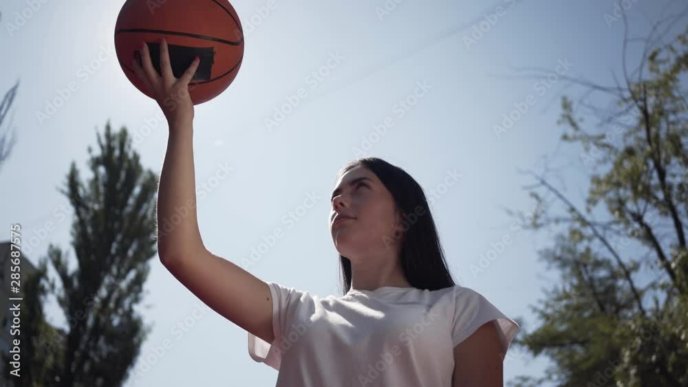 Portrait of attractive brunette woman throwing the ball up. Concept of ...