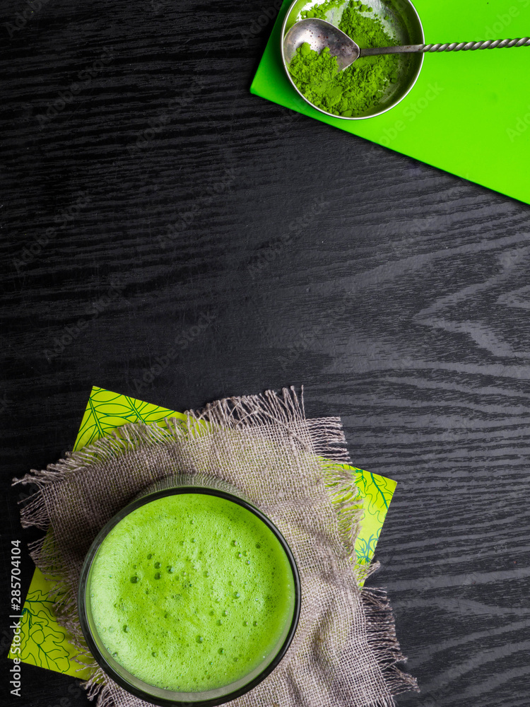 Matcha powder explosion and Matcha latte in glass made from finely ...