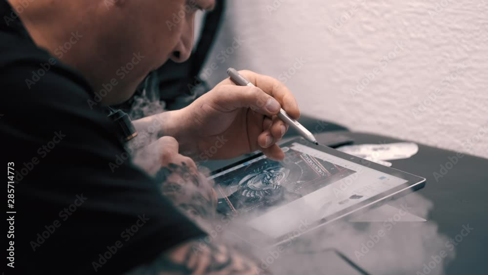 tattoo artist tracing image for new tattoo at the tattoo parlor Stock ...