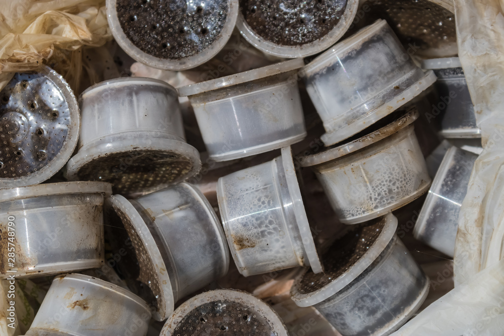 Closeup of used coffee capsules, recycle of plastic single-serve coffee ...
