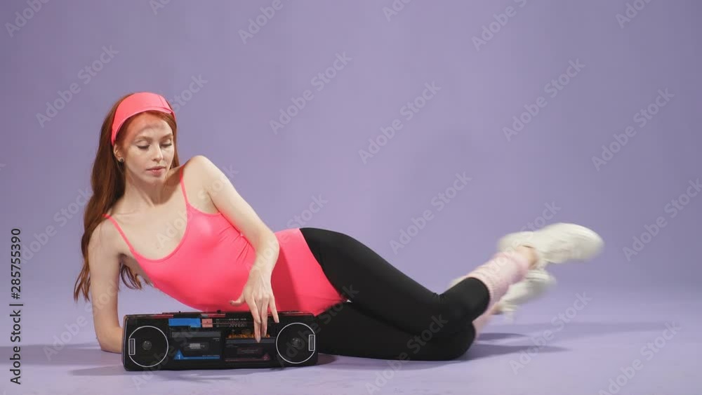 Fit ginger female model poses for commercial photoshoot for aerobics ...