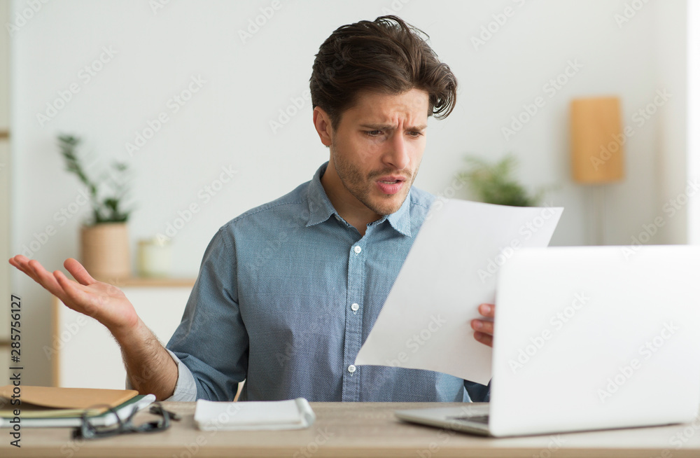 Confused Guy Reading Mail Letter Or Debt Notification Indoors Stock ...