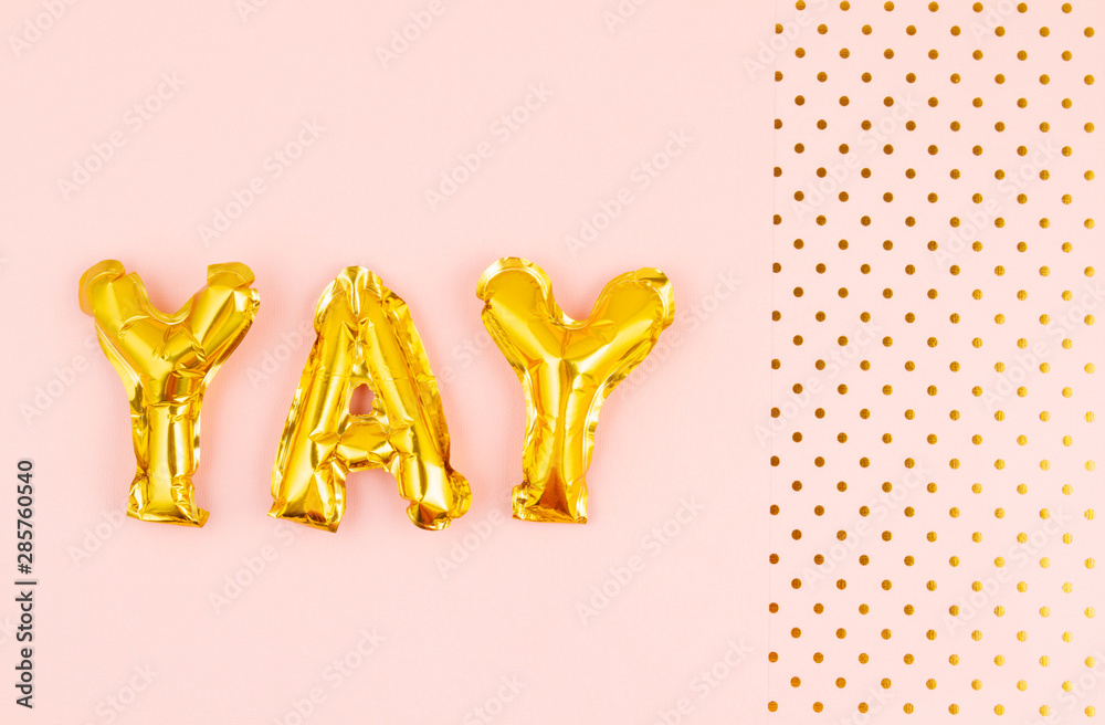Inflated letters yay ove the pastel background with golden polka dots ...