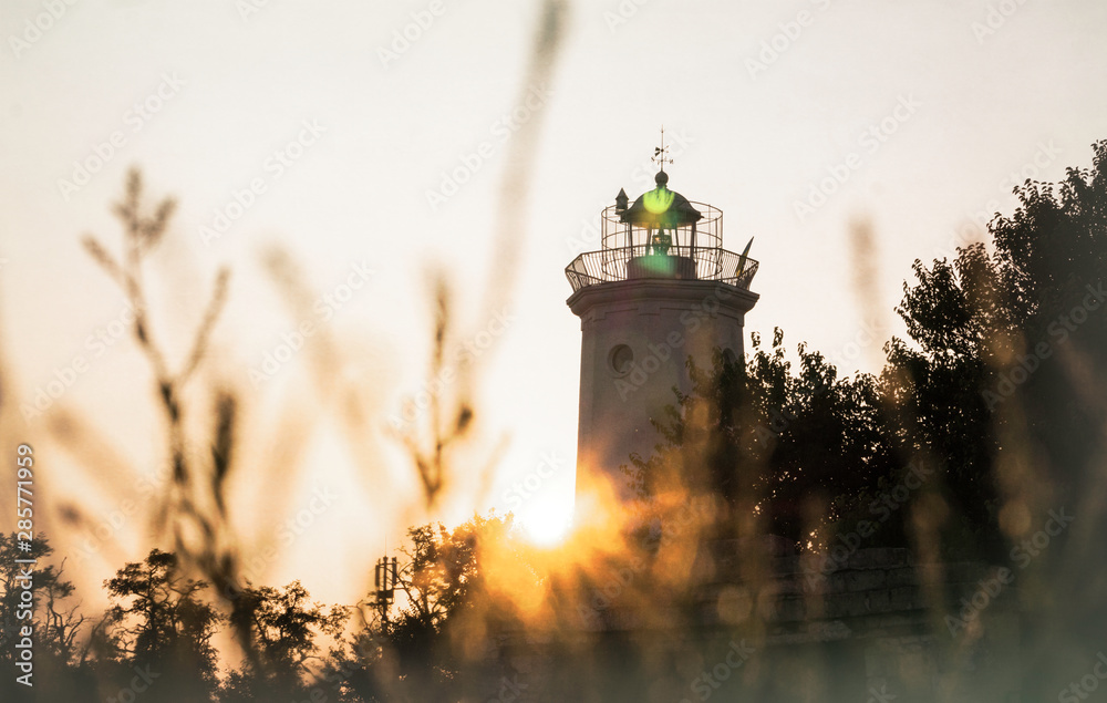 Tower of the old lighthouse against the evening sky. Countryside ...