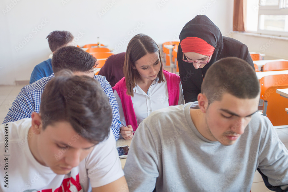 Female muslim professor explain lesson to students and interact with ...