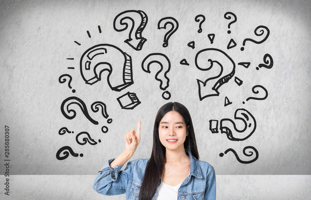 Question Marks with young woman in a thoughtful pose.Asianl woman with ...