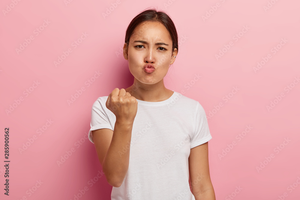Picture of angry dissatisfied Asian woman clenches fist with ...