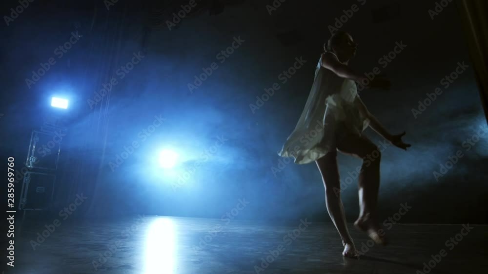 Modern dance woman in a white dress dances a modern ballet, jumps ...