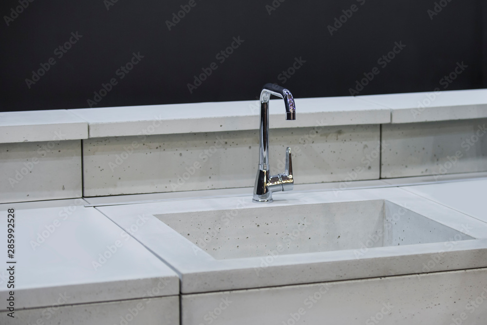 Modern kitchen, the water tap and concrete kitchen sink. Concrete ...