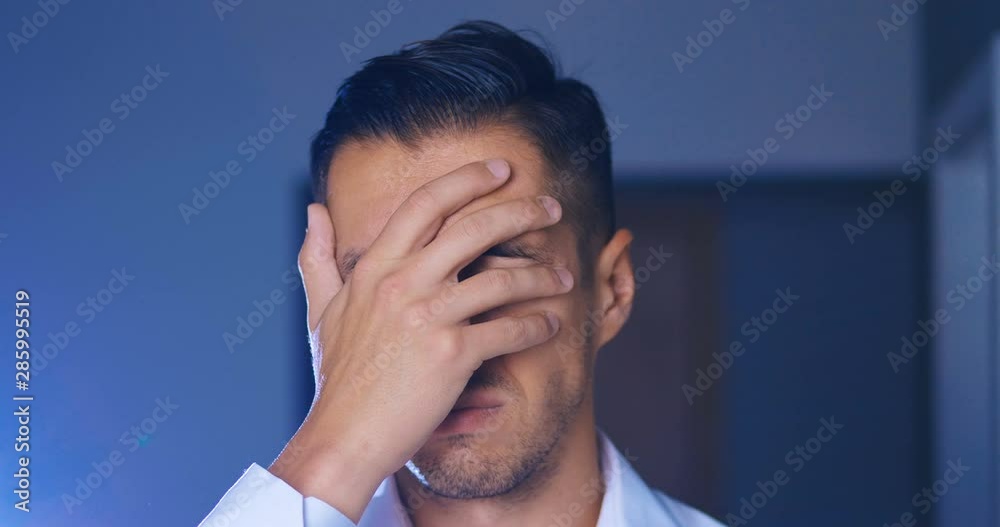 Portrait of attractive man making facepalming pose with hand. Showing ...