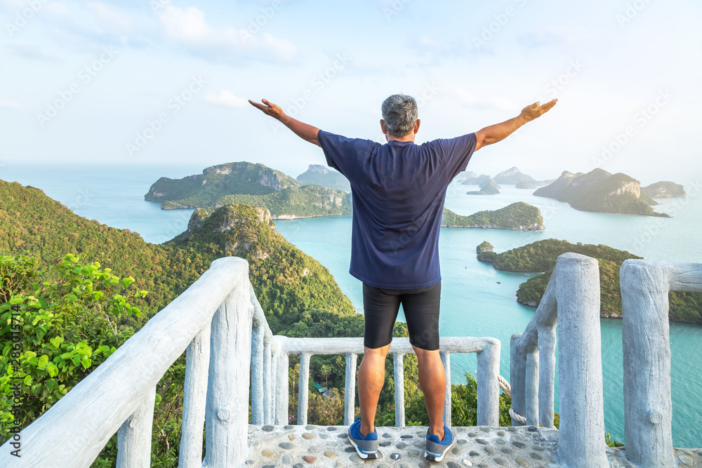 Backside view the man standing raising hands open arms achievements ...