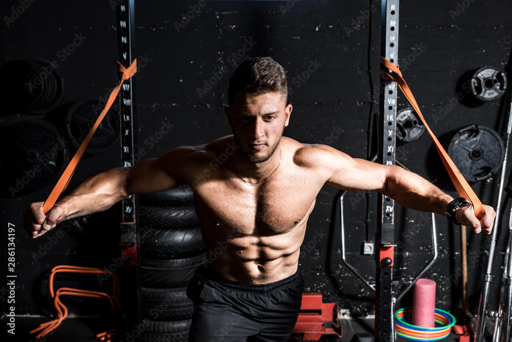 Young strong focused fit muscular man chest stretching workout in ...