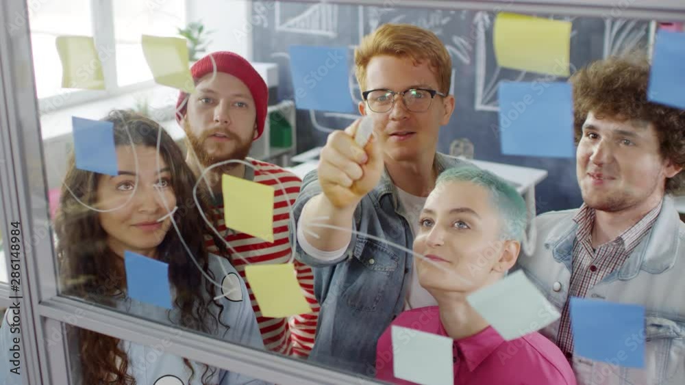 Video Stock Medium shot of young creative team standing in front of ...