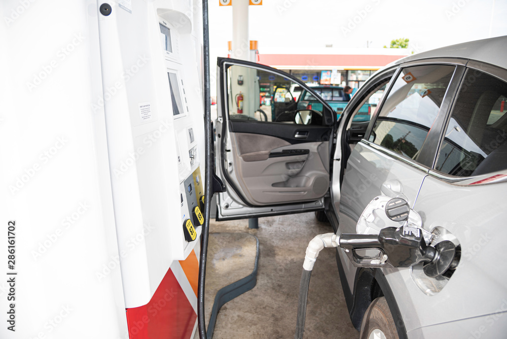 Filling A Vehicle’s Fuel Tank At A Gas Station Stock Photo | Adobe Stock