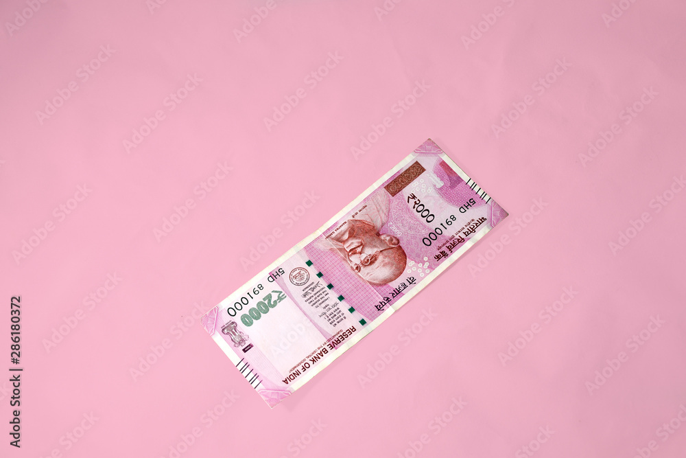 Modern Indian Two Thousand Rupees Currency Note on a minimal pink ...