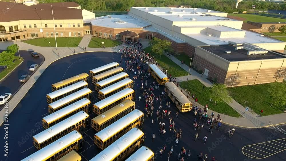 school buses deliver kids to a high school Stock Video | Adobe Stock