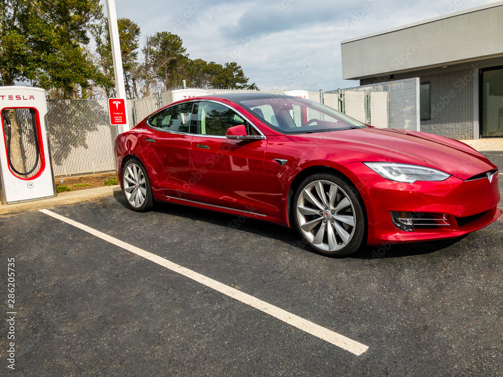 Tesla Red Model S Supercharging Electric Car Plugged In Stock Photo ...