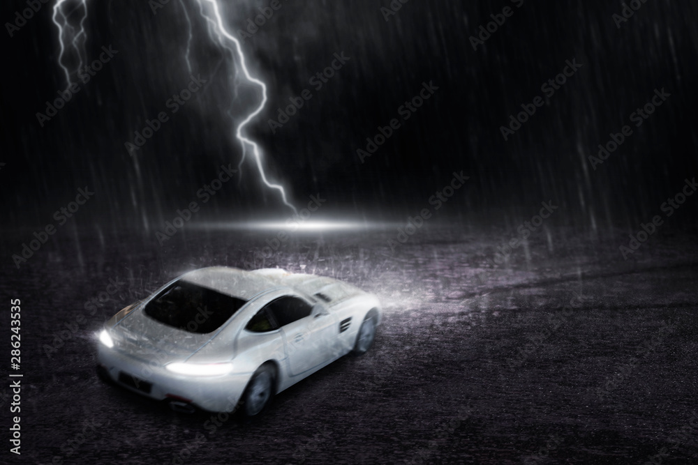 The white sports car that focuses on the back, runs on a road with rain ...