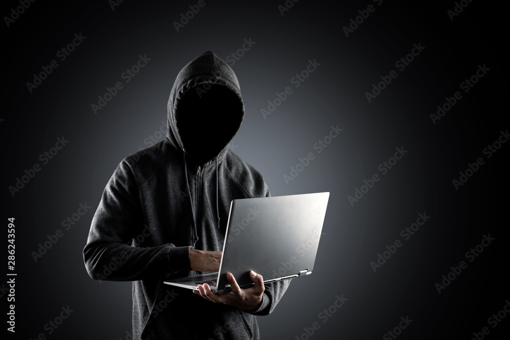 Cybercrime, hacking and technology crime. no face hacker with laptop on ...