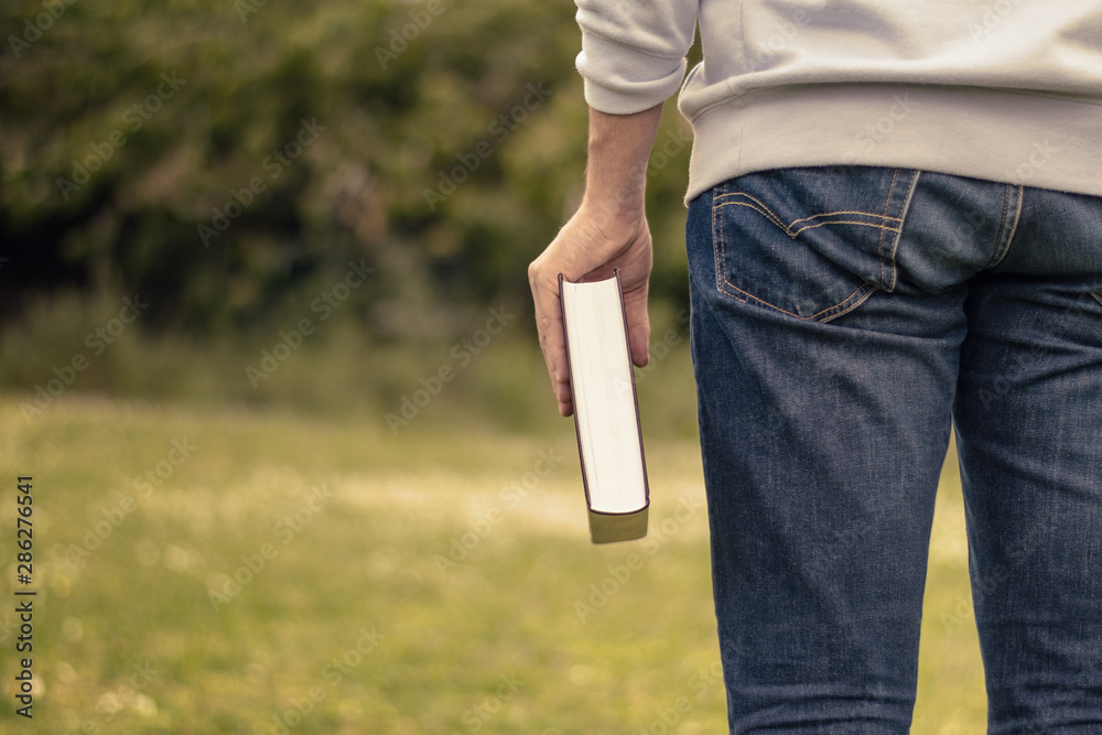 Christian worship and praise. Young man his holding the Holy Bible in ...