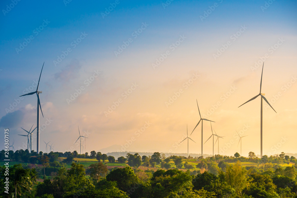 Green energy concept, eco power. Wind turbine located along the hill ...
