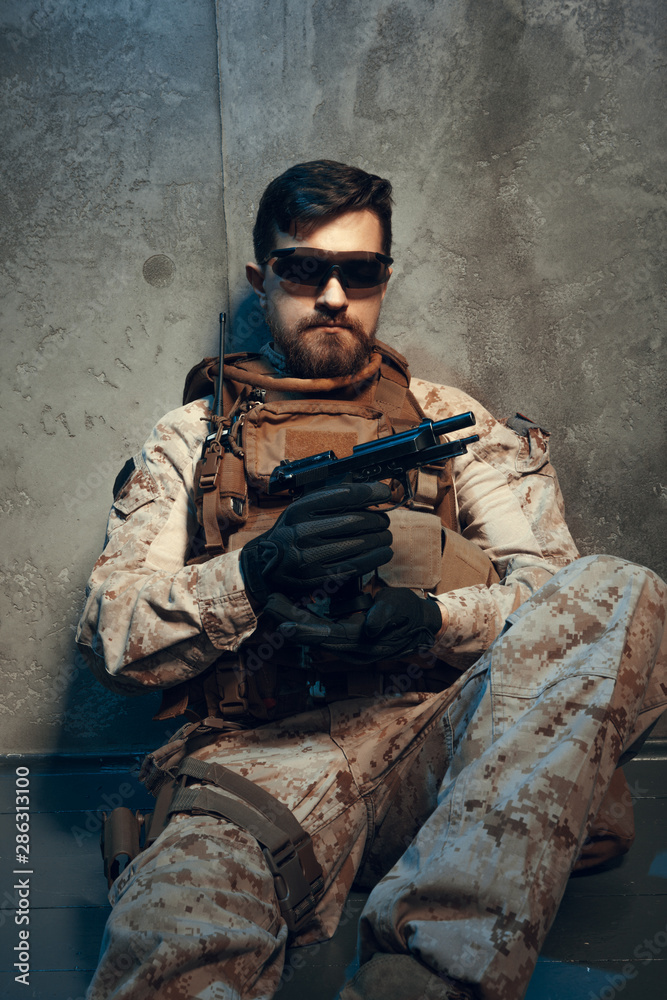 American private military contractor holding rifle. Image on a dark ...
