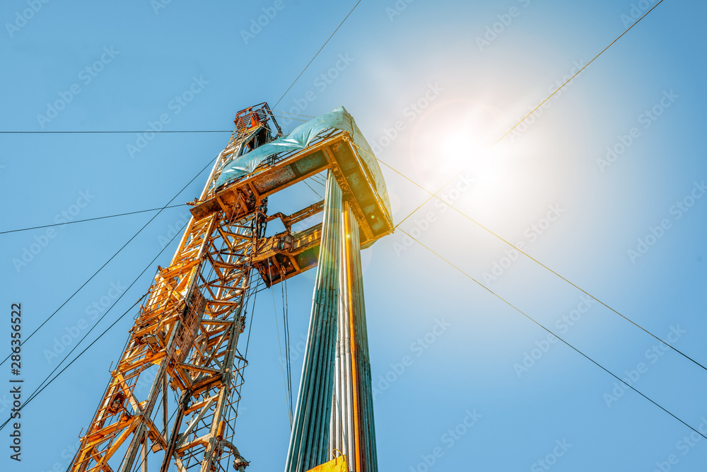 Onshore land rig in oil and gas industry. Oil drilling rig against a ...