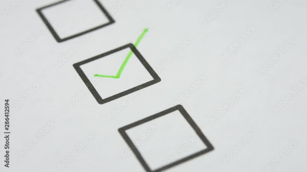 green ink pen make a check mark sign in check box list on white paper ...