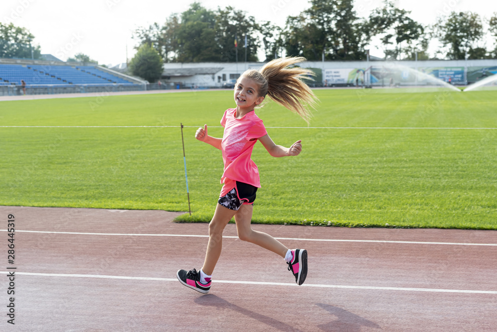 Side view of little girl running Stock Photo | Adobe Stock