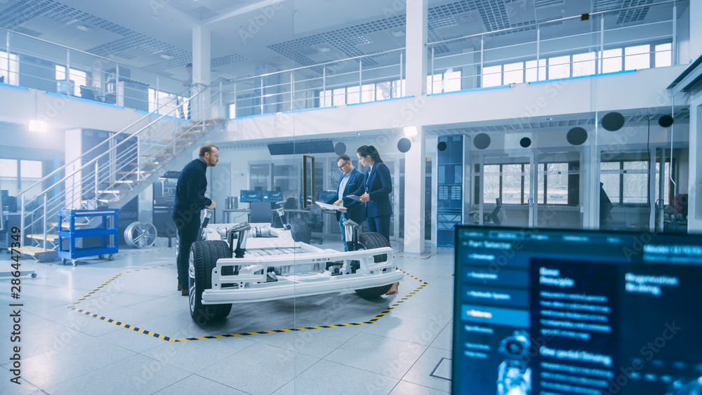 Automotive Design Engineers Talking while Working on Electric Car ...