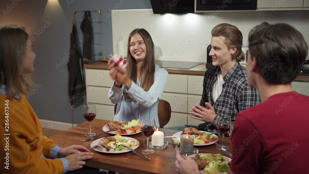 Group of four joyful friends, two couples, having festive dinner in ...