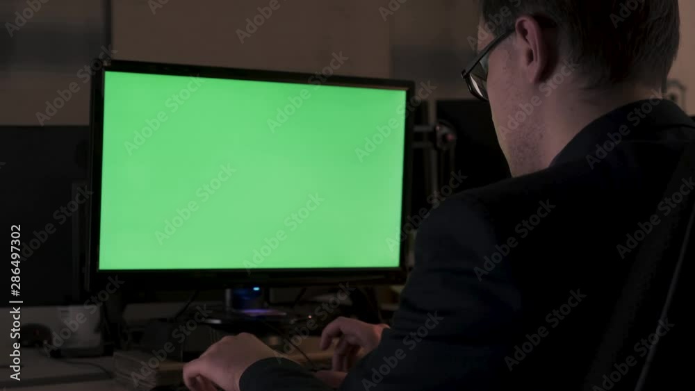 Office worker working at computer with green screen. Stock footage. Man ...