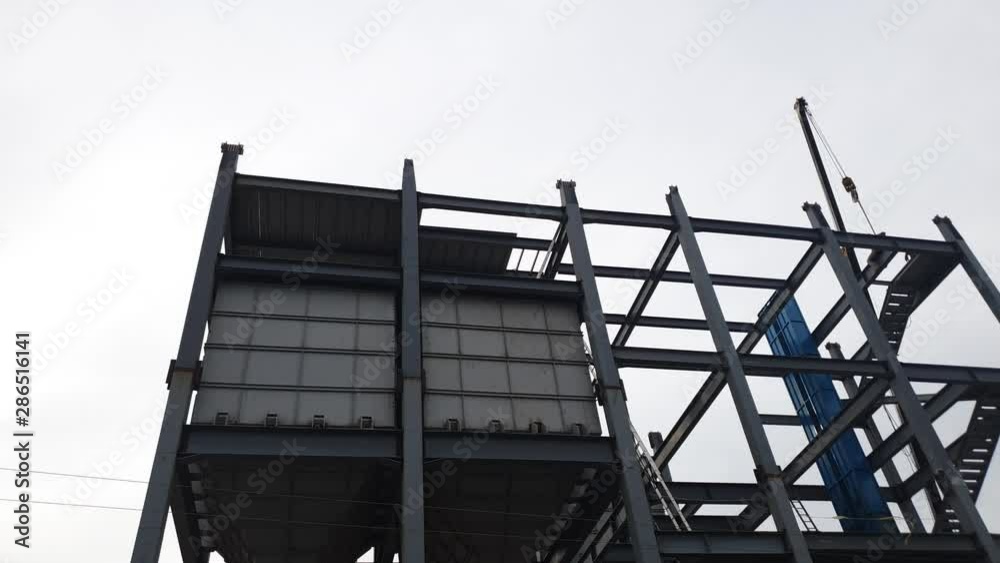 Construction of a building made of iron. Iron frame building. The ...