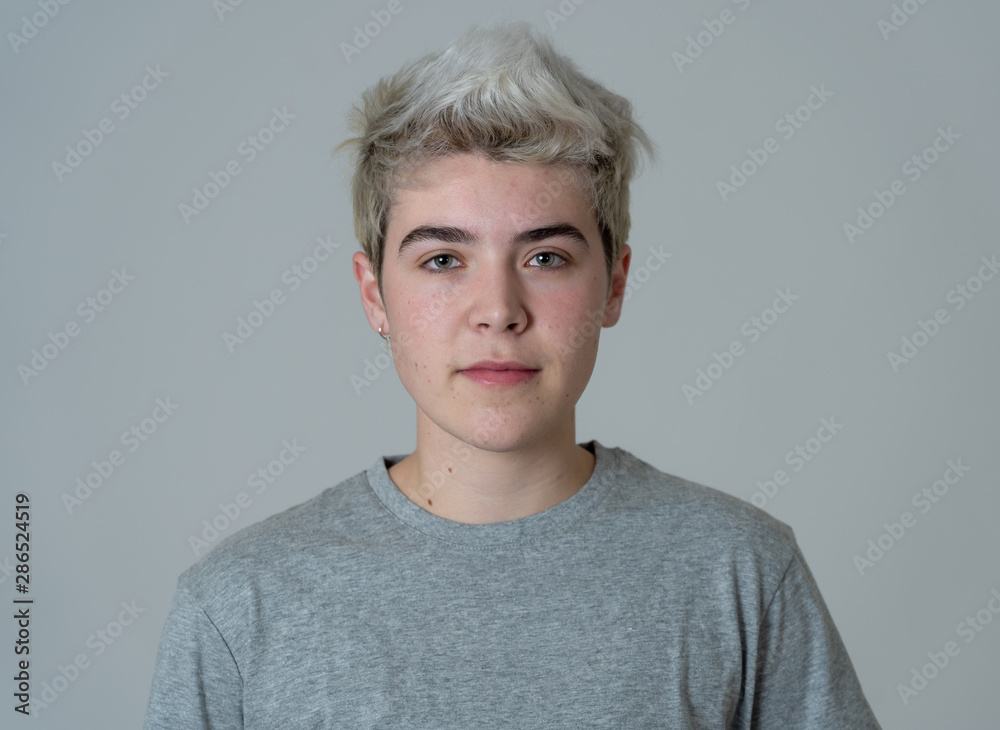 Natural portrait of young handsome transgender boy posing with neutral ...