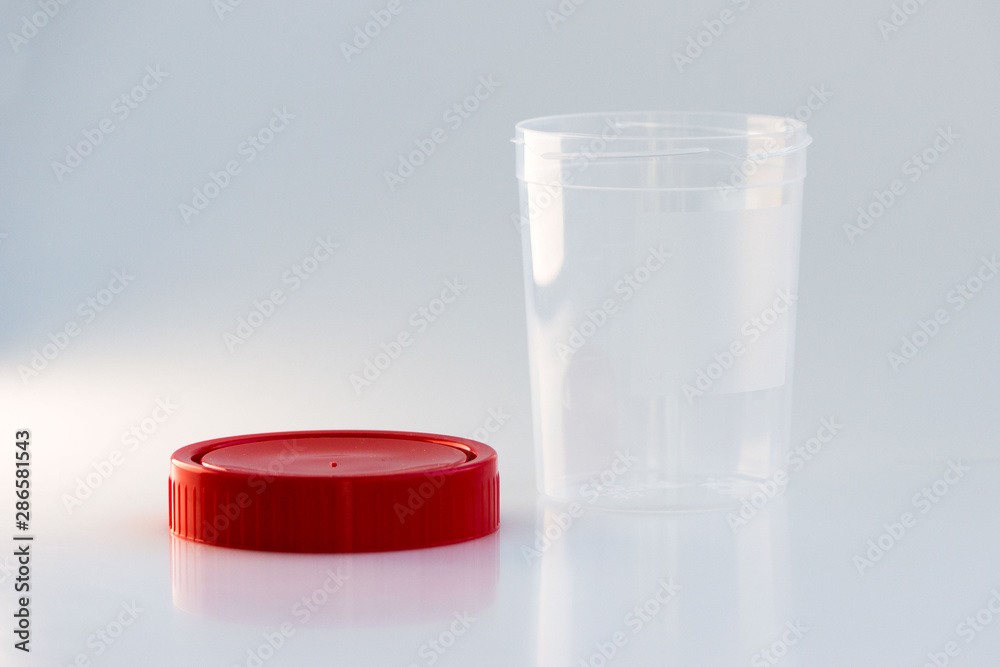 transparent plastic jar with a red lid on a white background. for ...