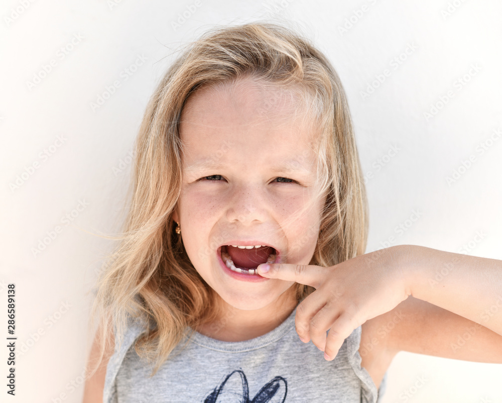 Young six years old baby girl kid showing off her first missing milk ...