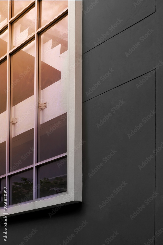 Side view of geometric patterns of staircase in glass wall frame of ...